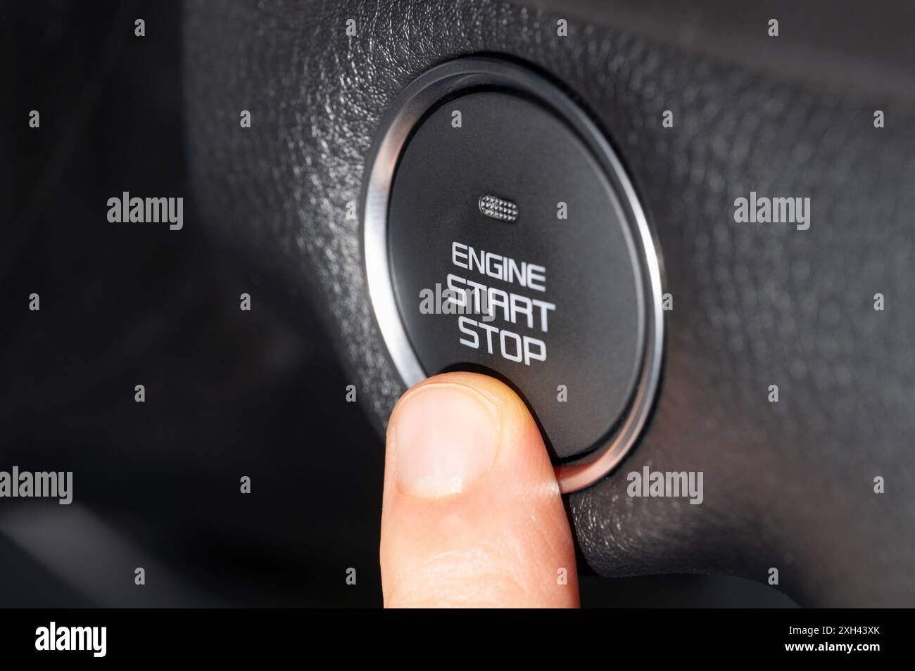 Finger push start stop engine button close up view Stock Photo - Alamy