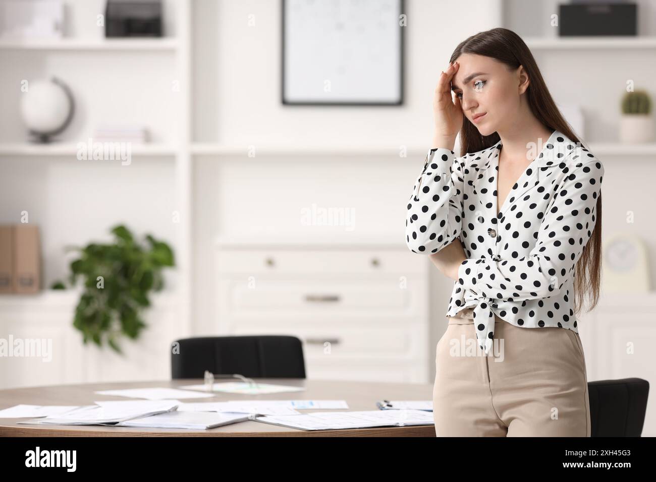 Embarrassed woman in office, space for text Stock Photo - Alamy