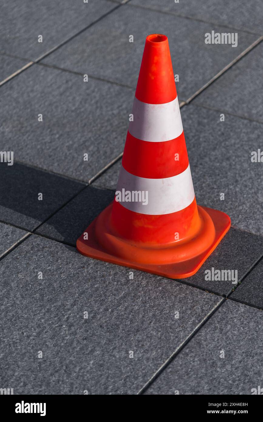 Traffic Cone Standing On Sidewalks Granite Tiles Stock Photo - Alamy