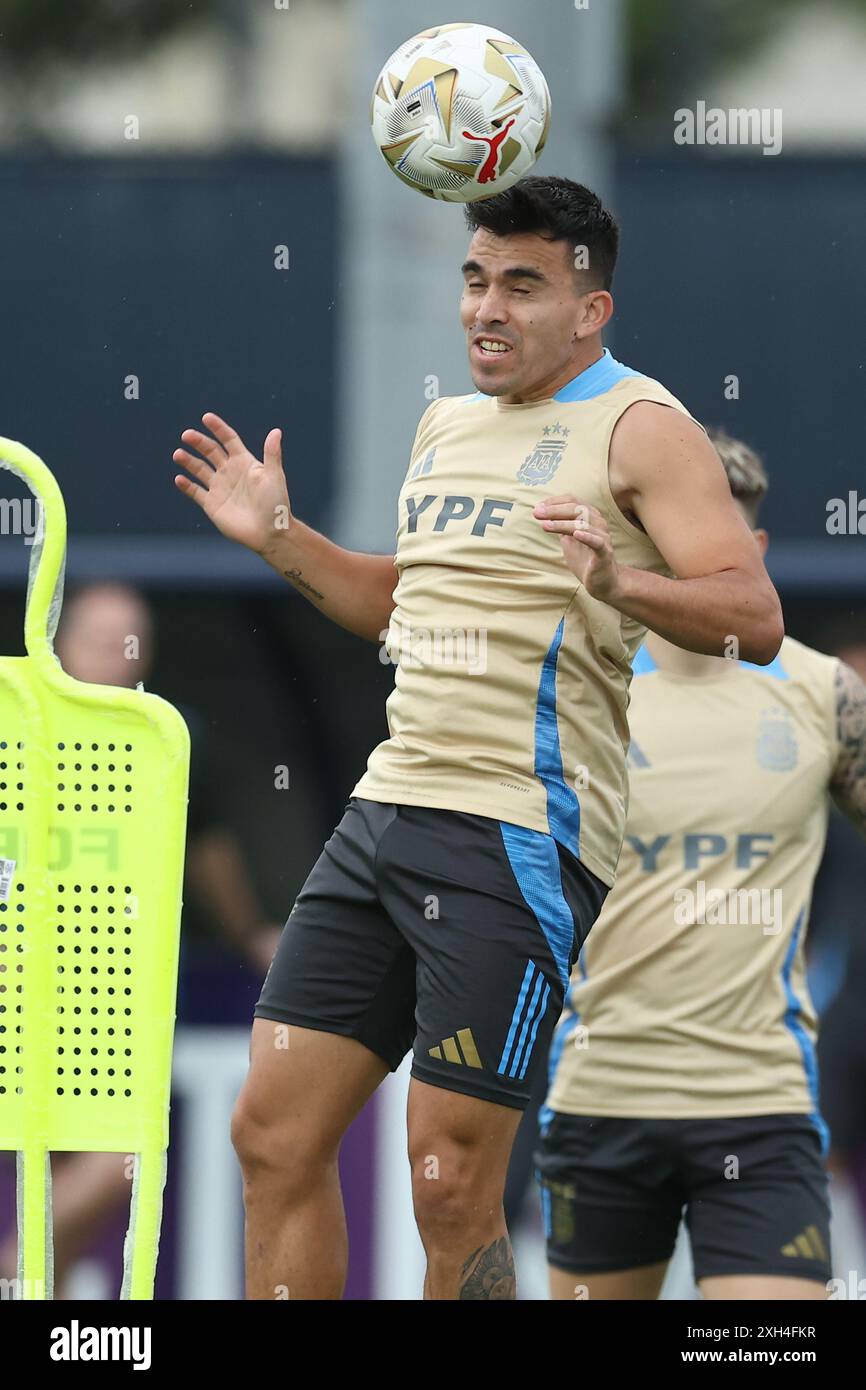 Argentina's midfielder Marcos Acuna (C) heads the ball during a ...