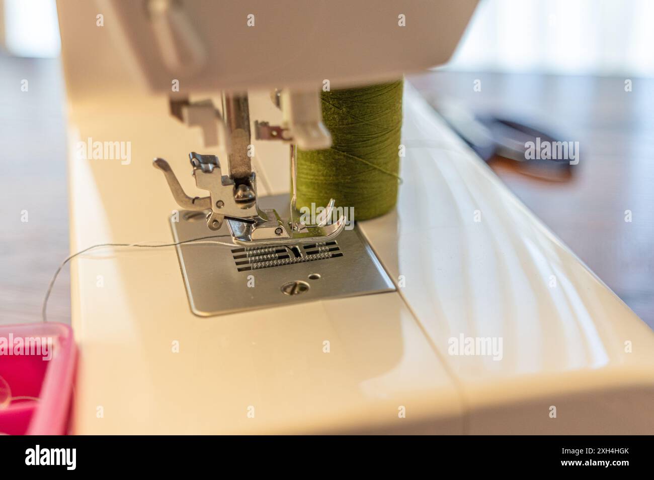 Electric sewing machine needle with spools of thread Stock Photo - Alamy