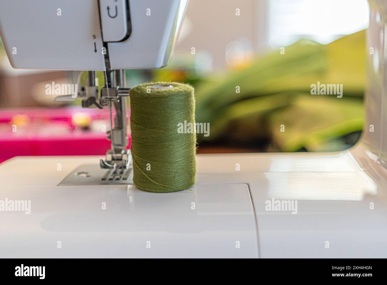 Electric sewing machine needle with spools of thread Stock Photo - Alamy