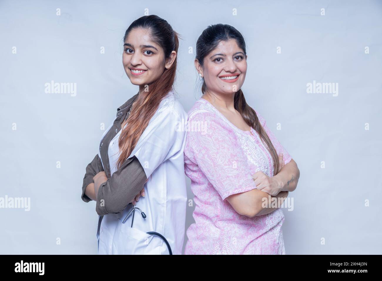 Indian mom and her daughter standing together hi-res stock photography ...