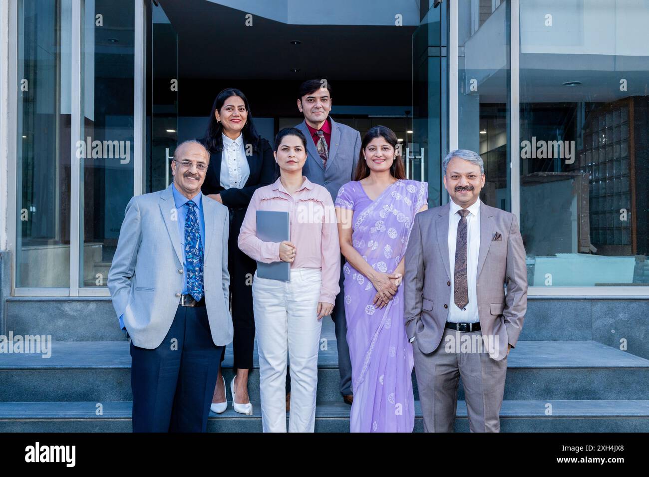 Group of indian corporate businesspeople standing outside office ...