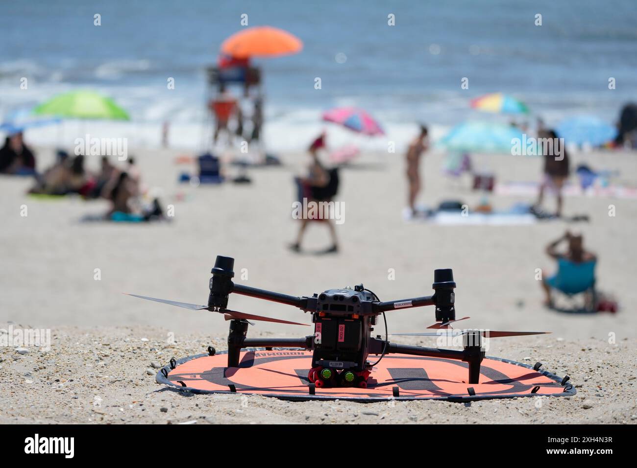 A drone with emergency flotation devices attached prepares to launch at ...