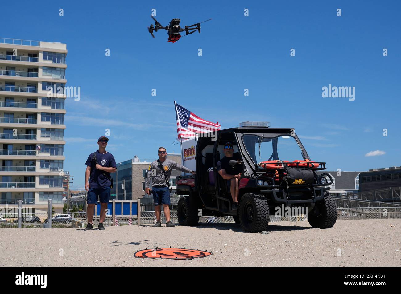 An FDNY drone pilot launches a drone at Rockaway Beach in New York ...