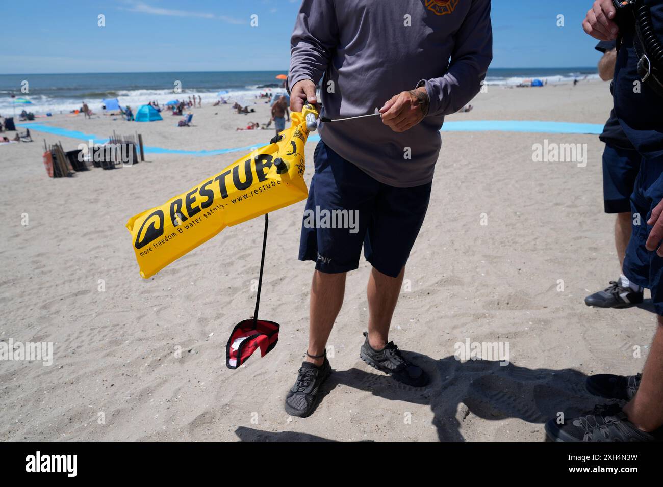 An FDNY drone pilot demonstrates an emergency flotation device, carried ...