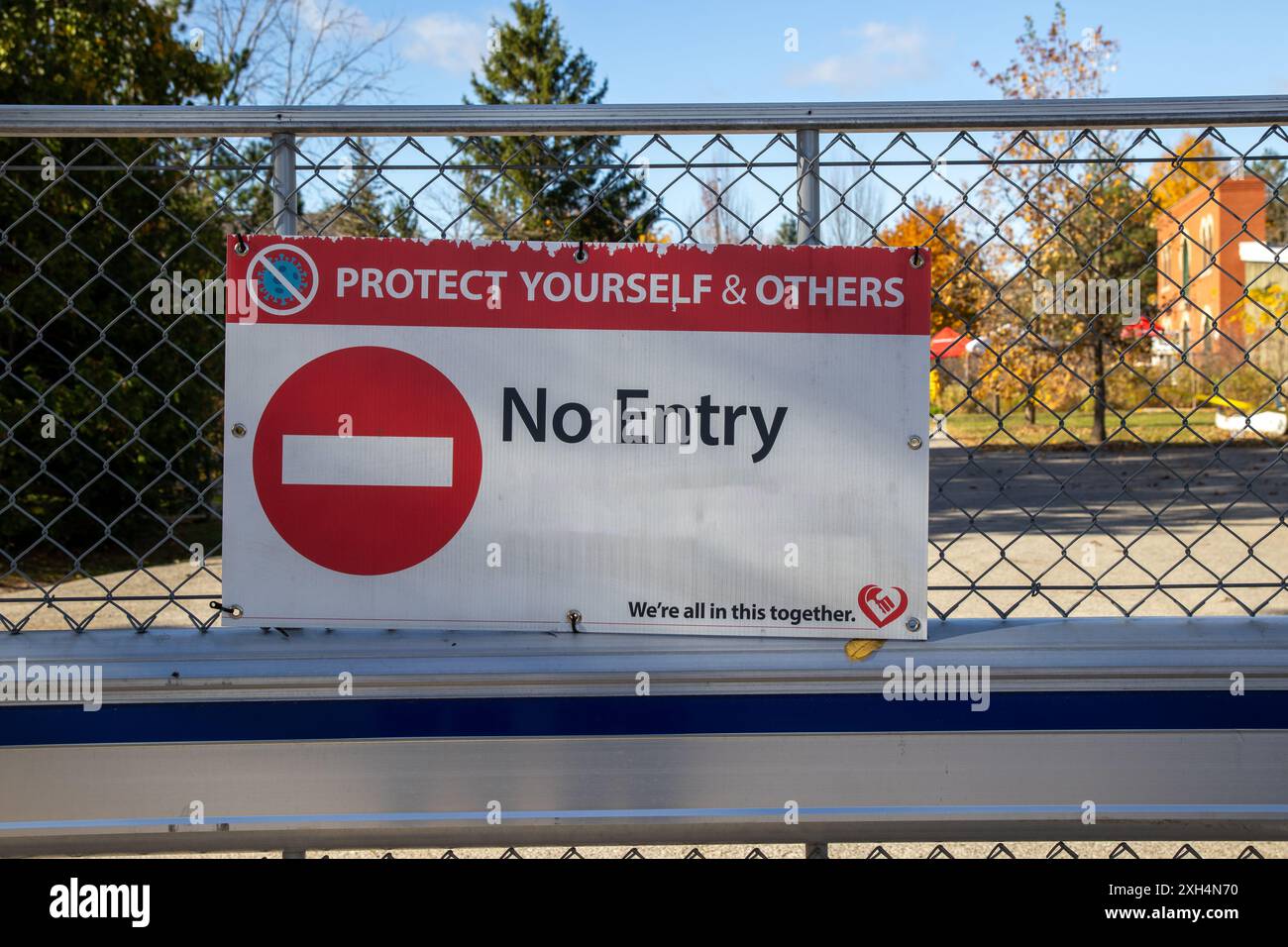 Red and white No Entry sign - metal fence backdrop - clear prohibition ...