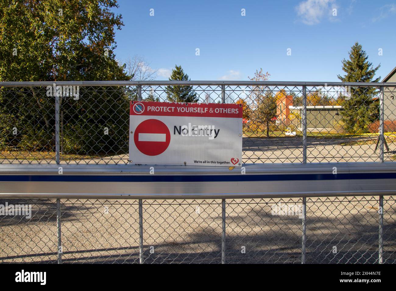 Red and white No Entry sign - metal fence backdrop - clear prohibition ...