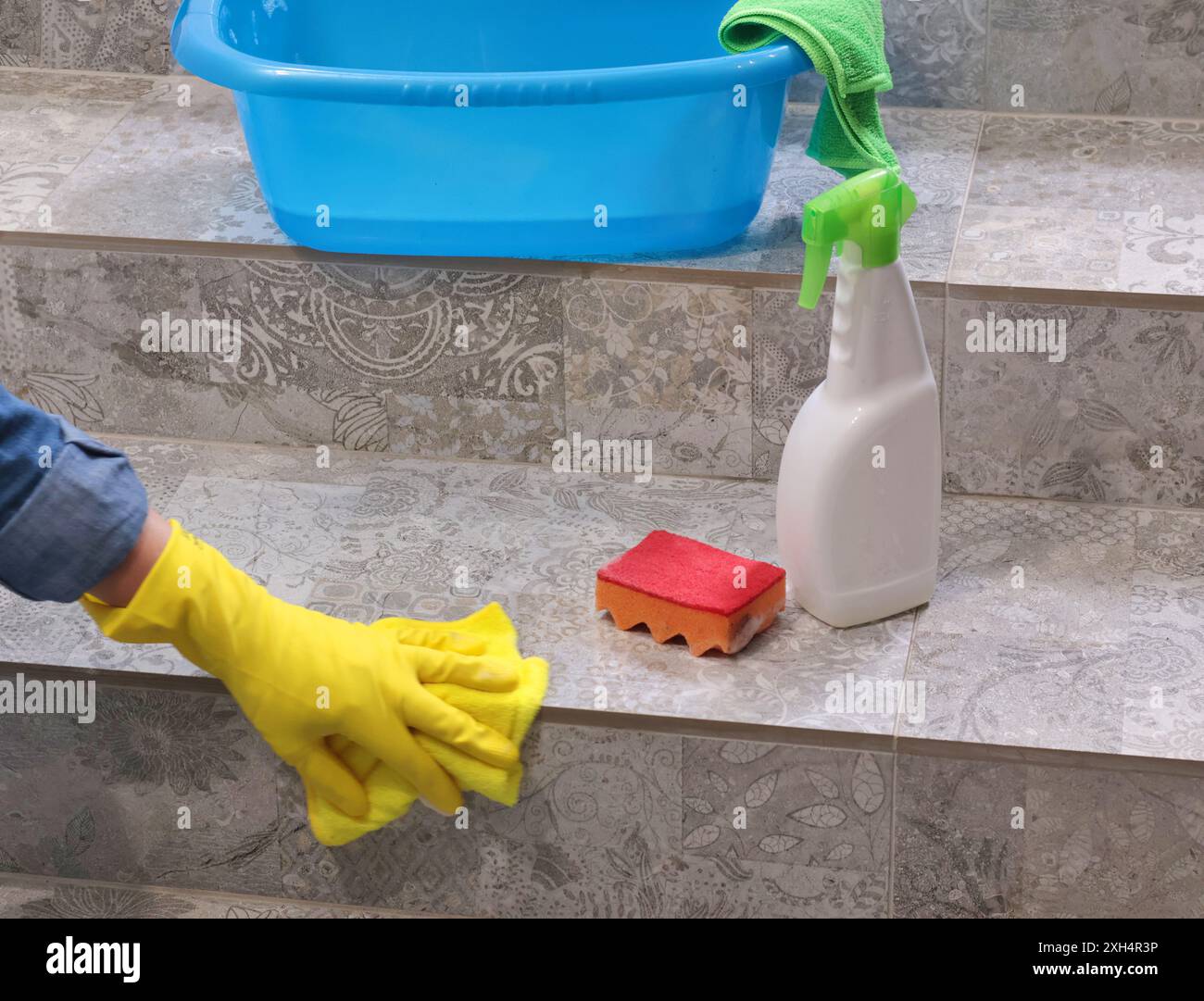 Woman in rubber gloves washes tile staircase in house. Cleaning and cleanliness, detergents ...