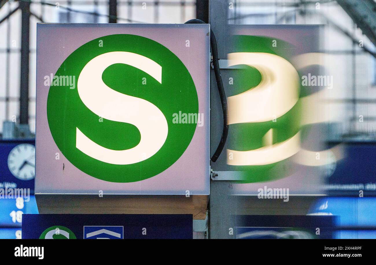 11 July 2024, Hesse, Frankfurt/Main: An S-Bahn symbol is reflected in a ...