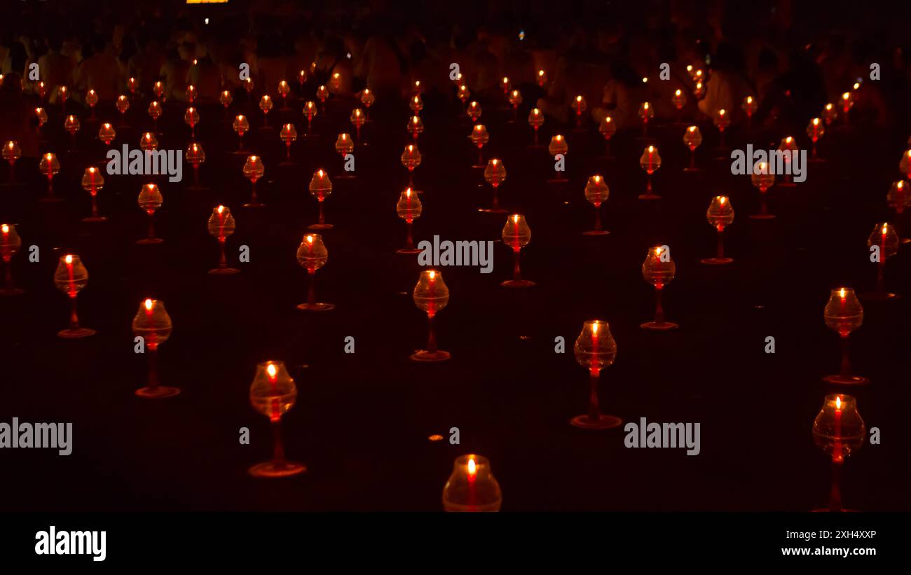 A large number of candles are lit at borobudur temple. The candles are ...