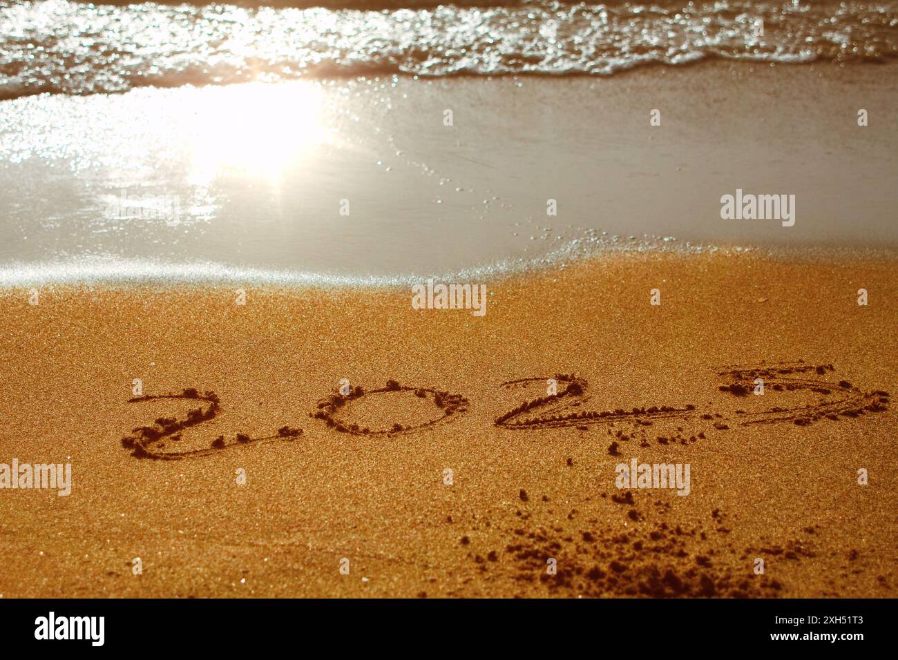 Sea sunrise of first new day for 2025 year text on beach sand Stock ...