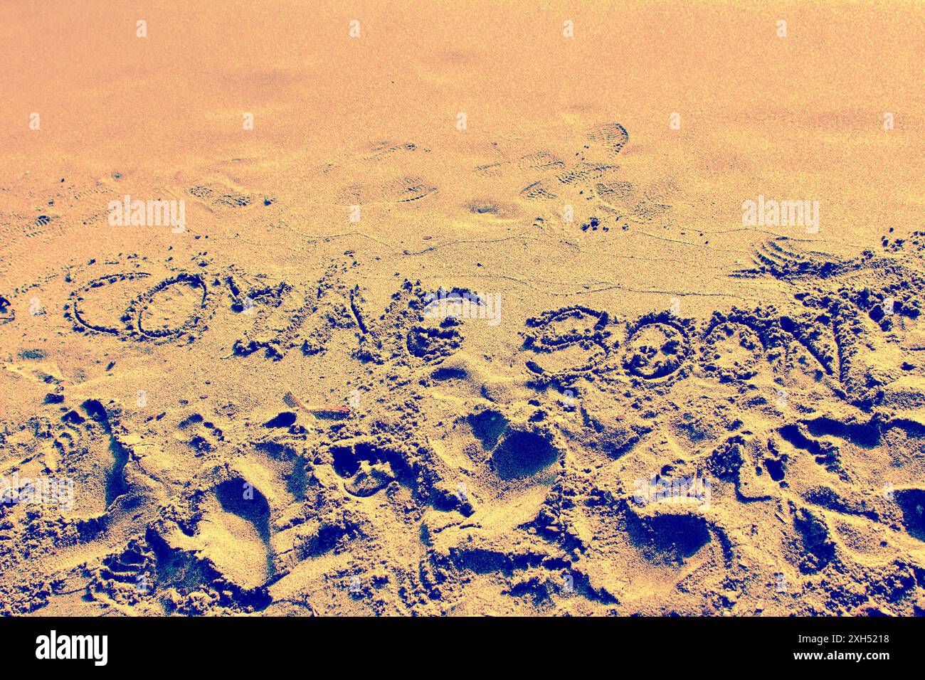 Coming Soon written on the sandy beach Stock Photo - Alamy