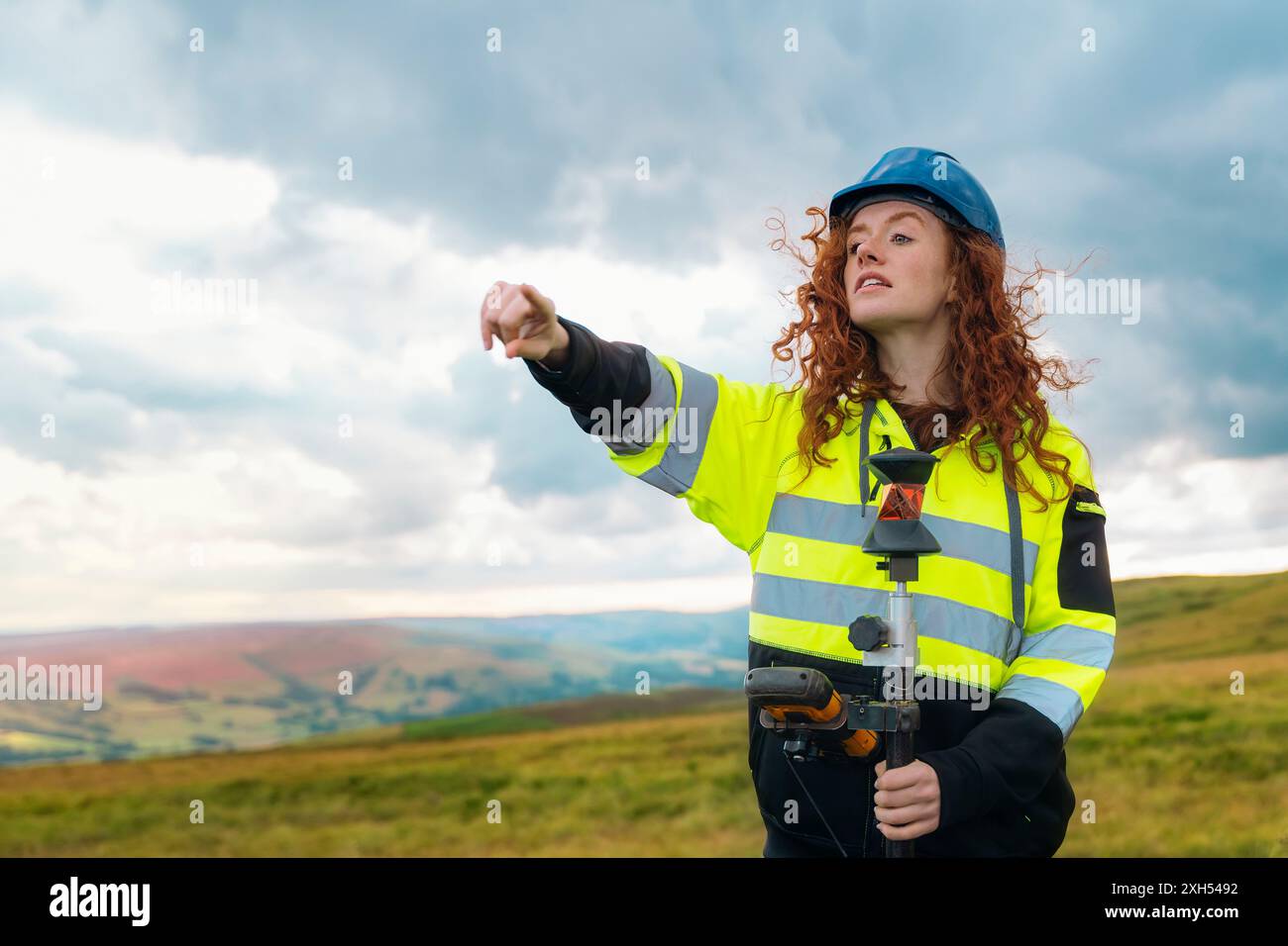 Female site engineer surveyor working with theodolite total station EDM ...