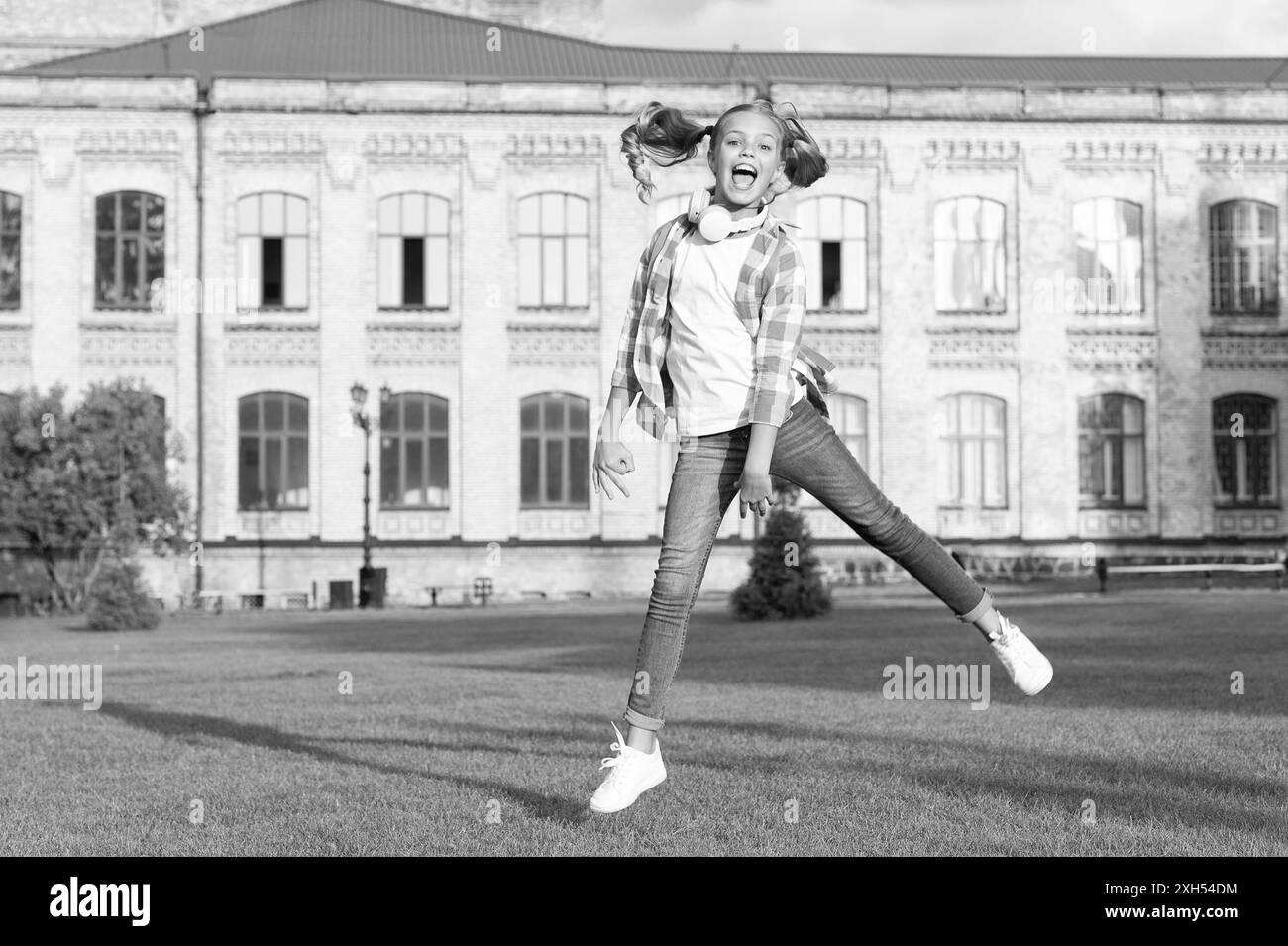 Happy active teen girl jumping in school yard outdoors, schooling Stock ...