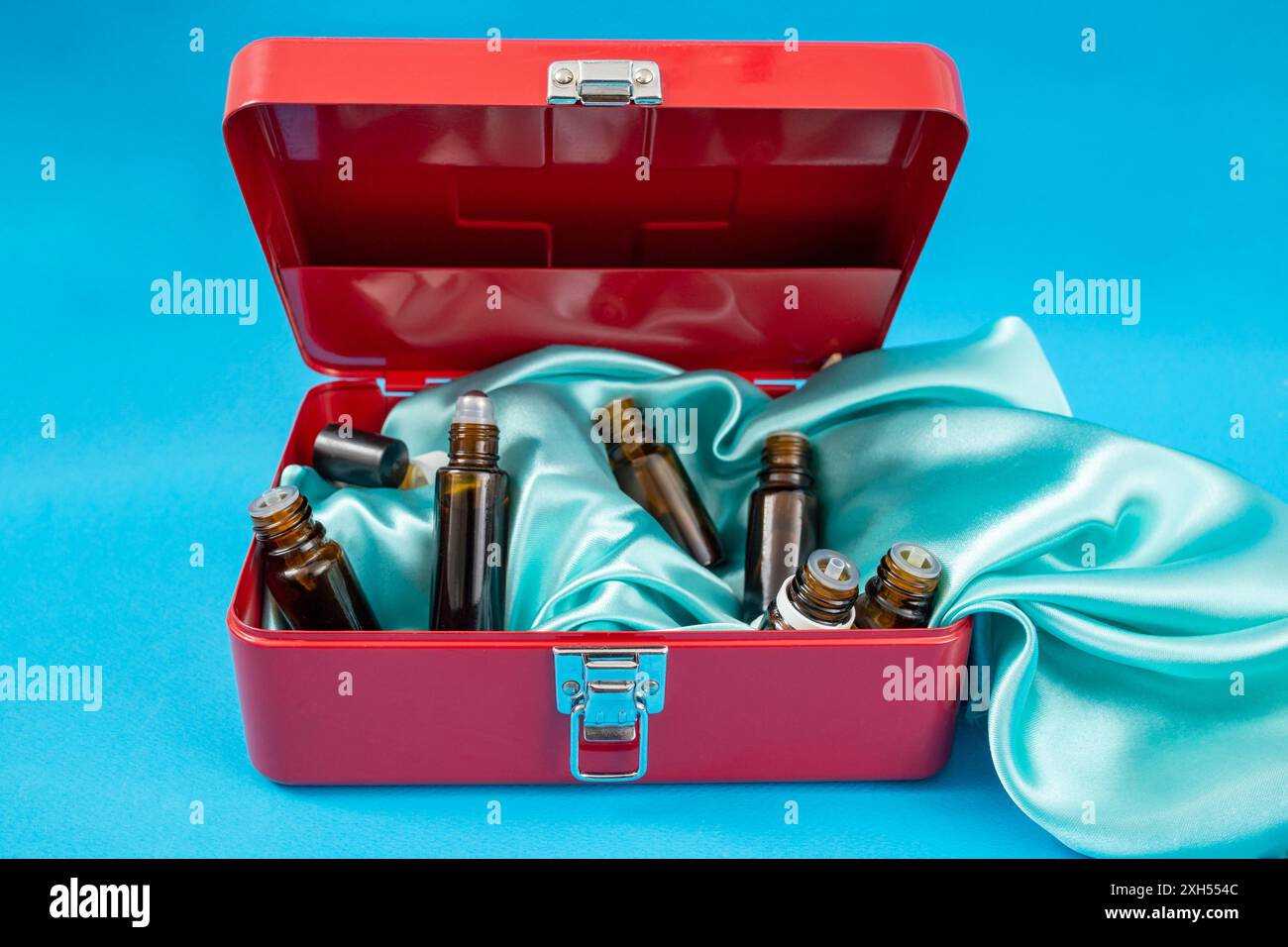 First aid kit metallic red case with essential oil bottles and ...