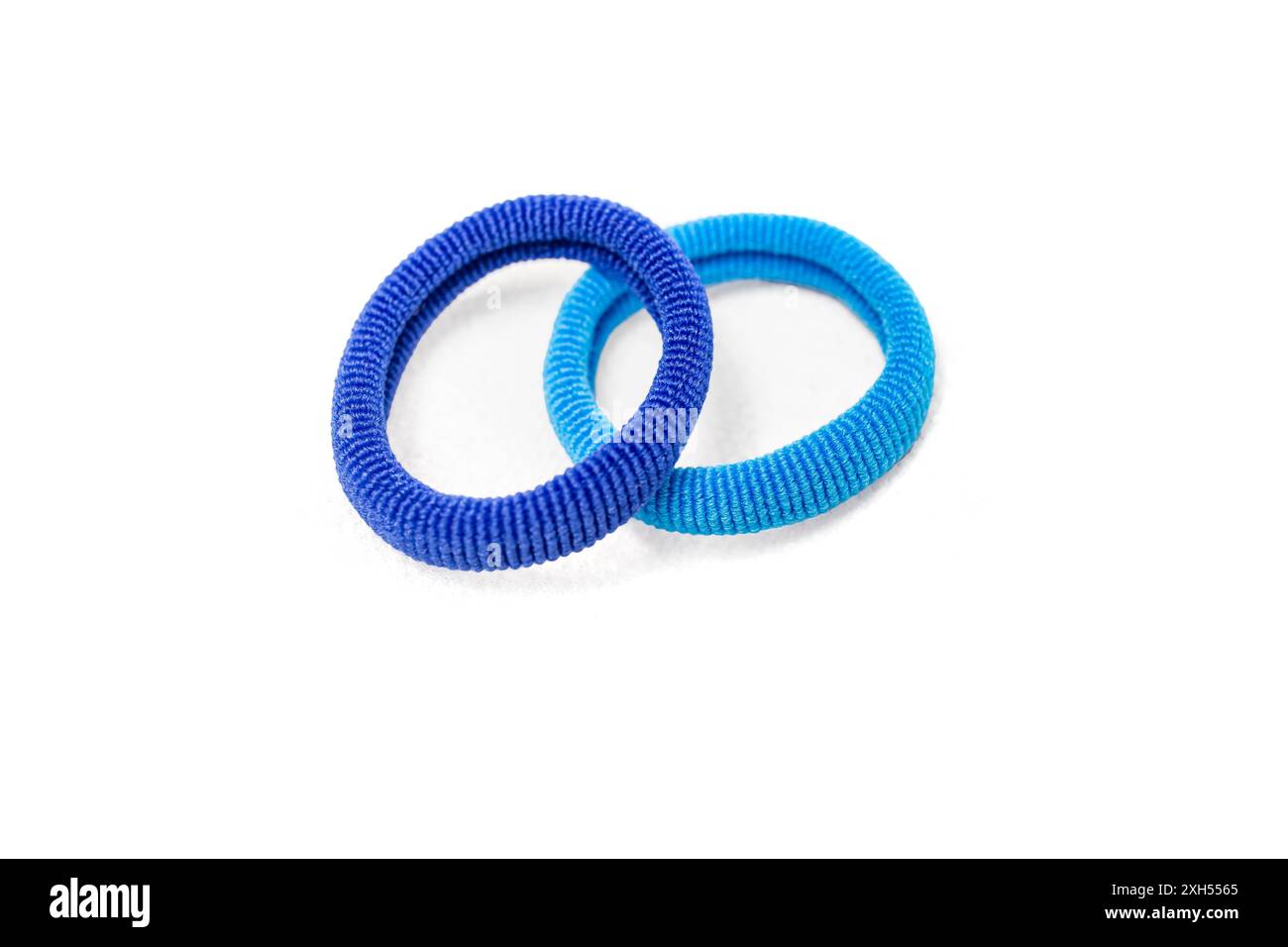 Two blue colored rubber bands for long hair isolated on white Stock ...