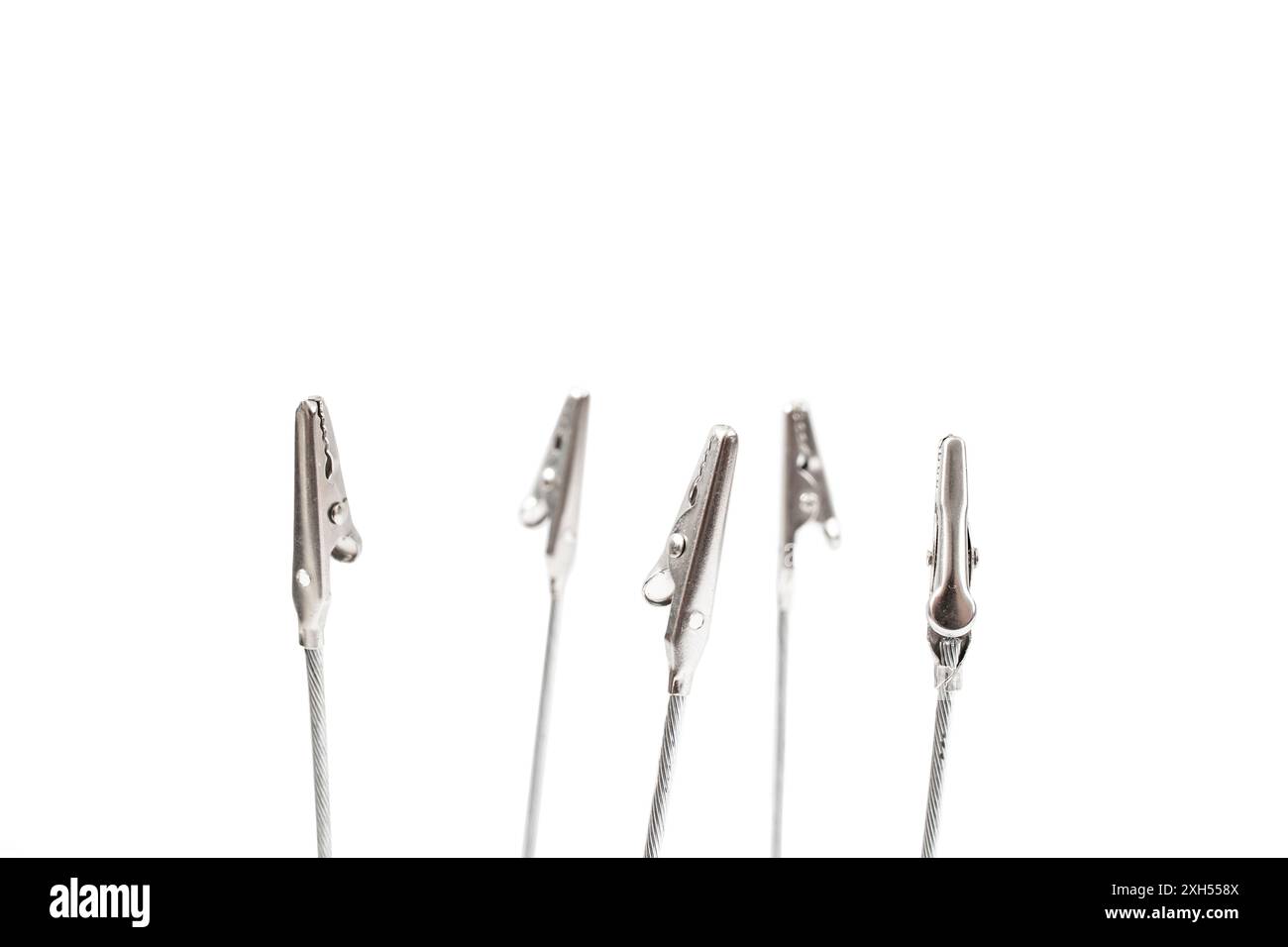 Alligator clips isolated on white background, defocused office supply ...