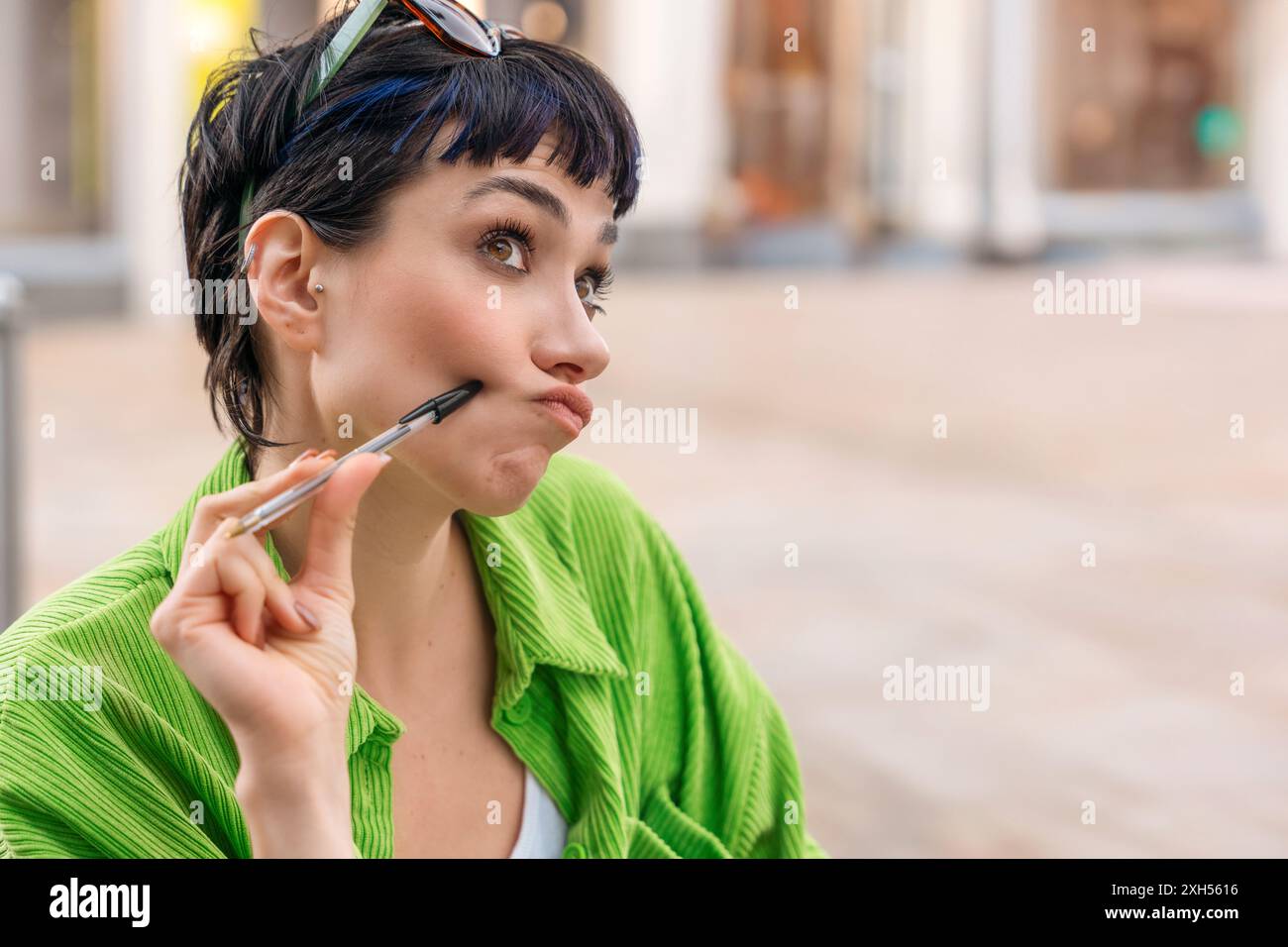 portrait of confused young woman student writing in a notebook, making ...