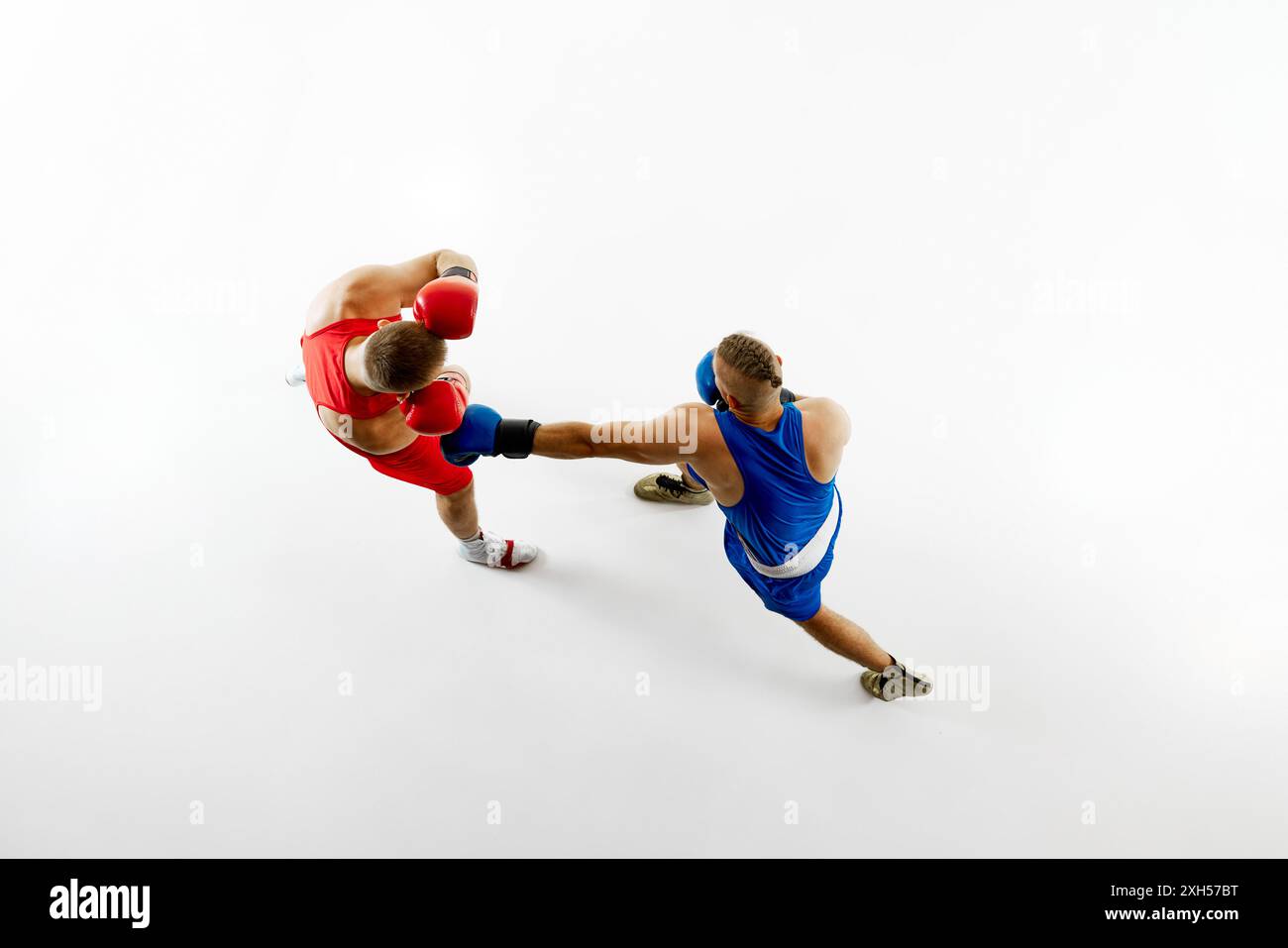 Aerial view of two men boxing, showcasing blue fighter's punch aimed at ...