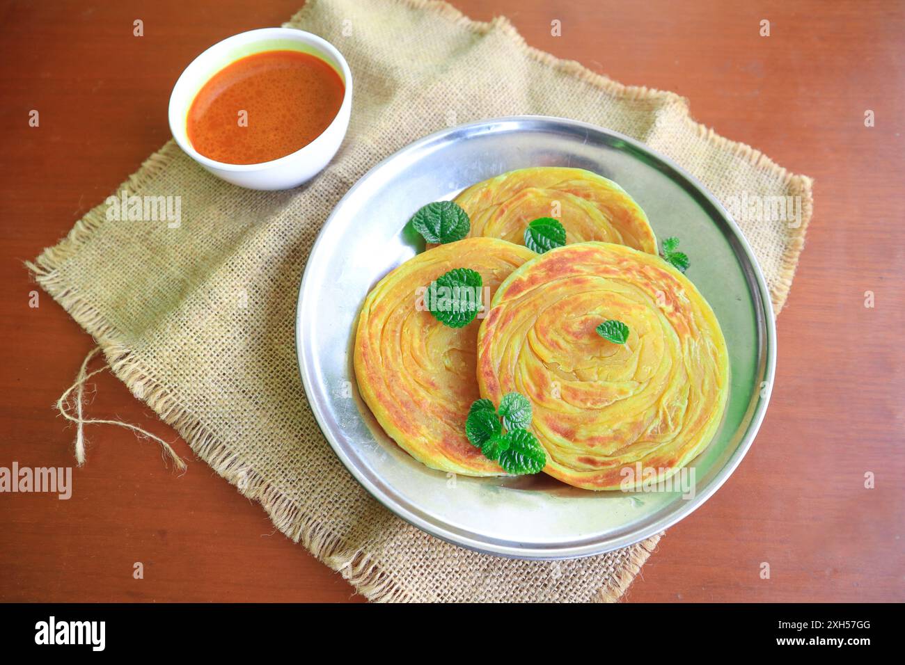 Roti Canai or Paratha Bread with Curry Sauce, Chilli Flakes and Yogurt ...