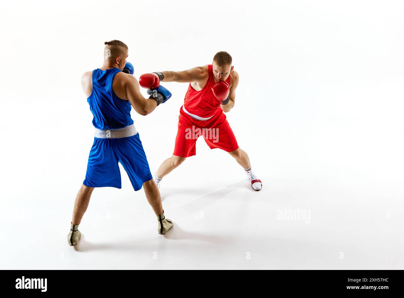 Dynamic scene of two athletes, one in red and one in blue, training ...