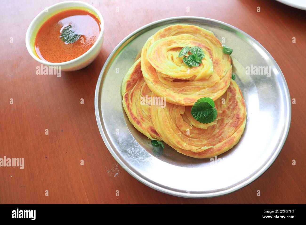 Roti Canai or Paratha Bread with Curry Sauce, Chilli Flakes and Yogurt ...