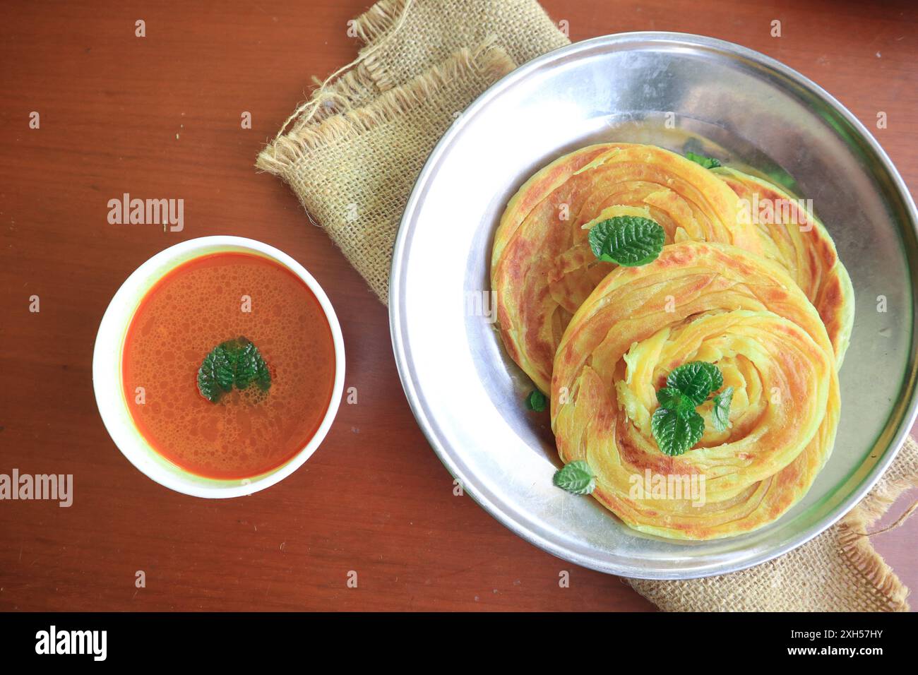 Roti Canai or Paratha Bread with Curry Sauce, Chilli Flakes and Yogurt ...