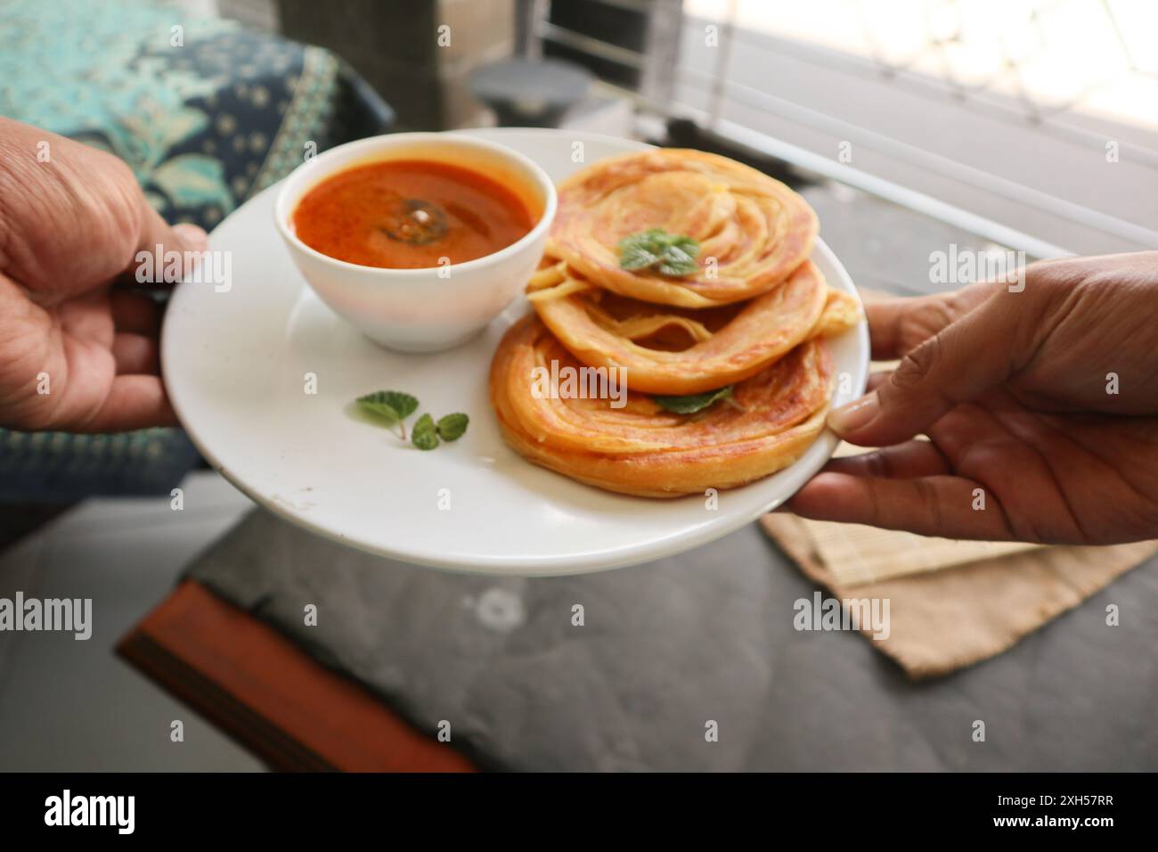 Roti Canai or Paratha Bread with Curry Sauce, Chilli Flakes and Yogurt ...