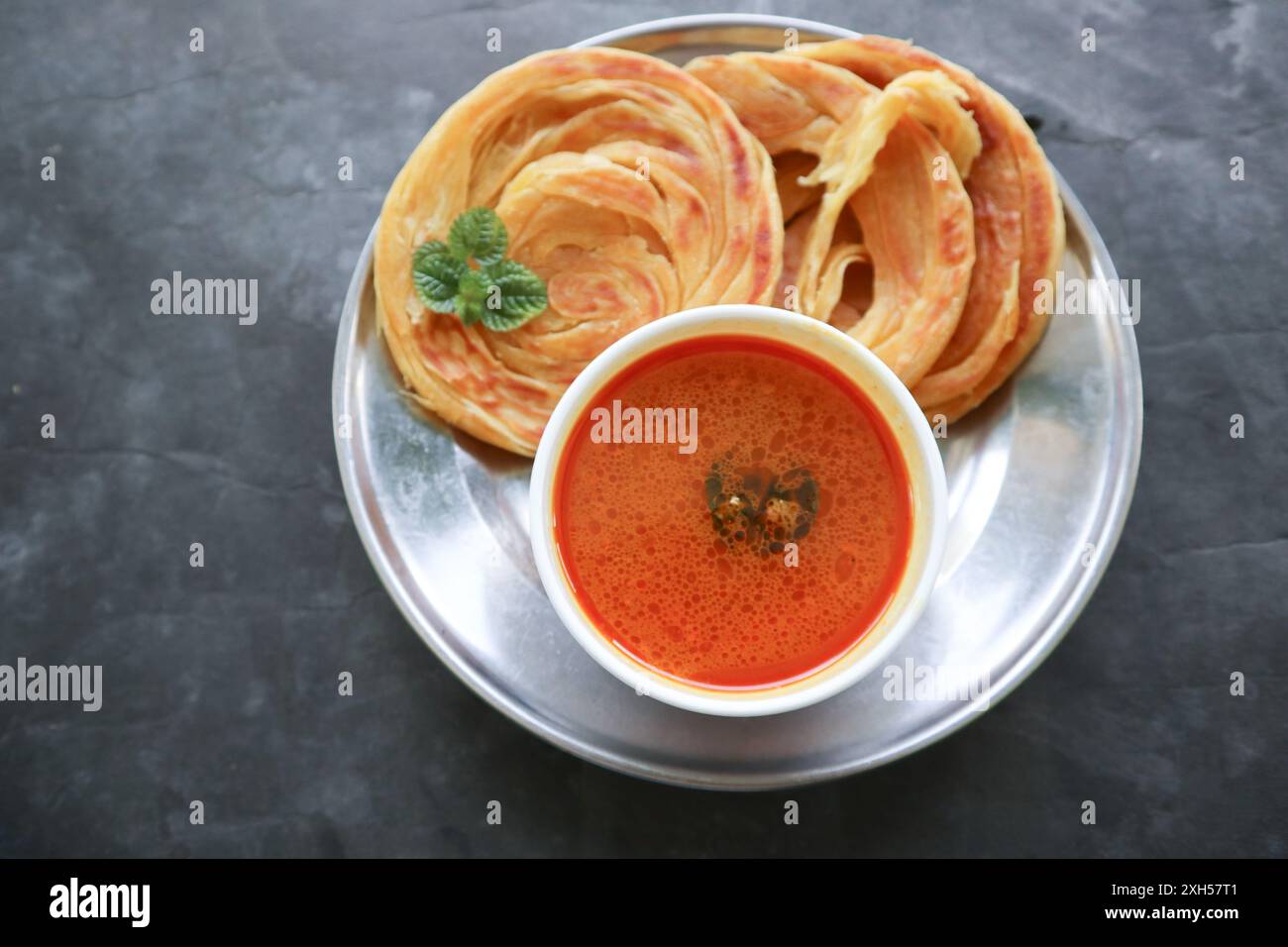 Roti Canai or Paratha Bread with Curry Sauce, Chilli Flakes and Yogurt ...