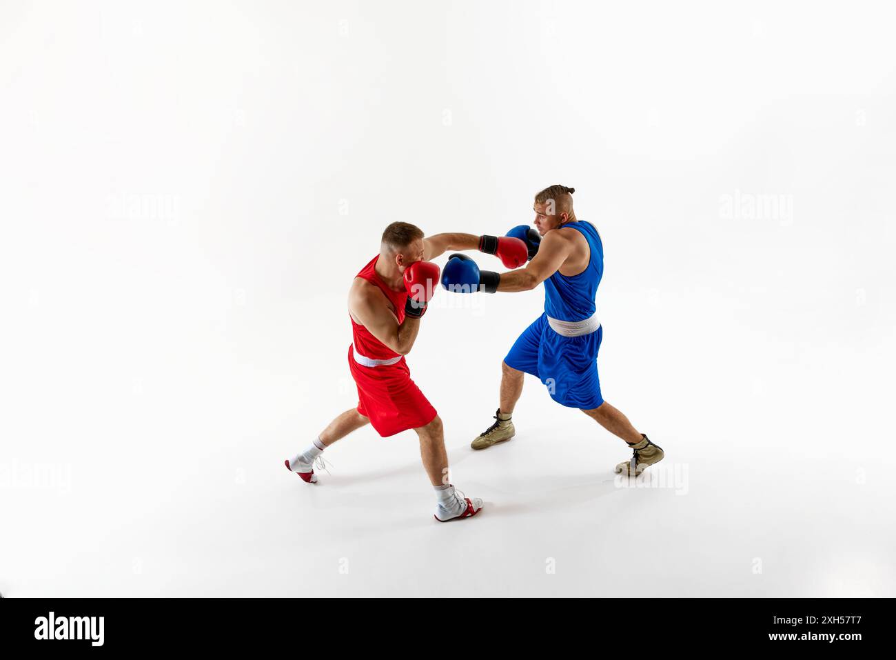 Boxing match in progress, red boxer facing blue boxer, both ...