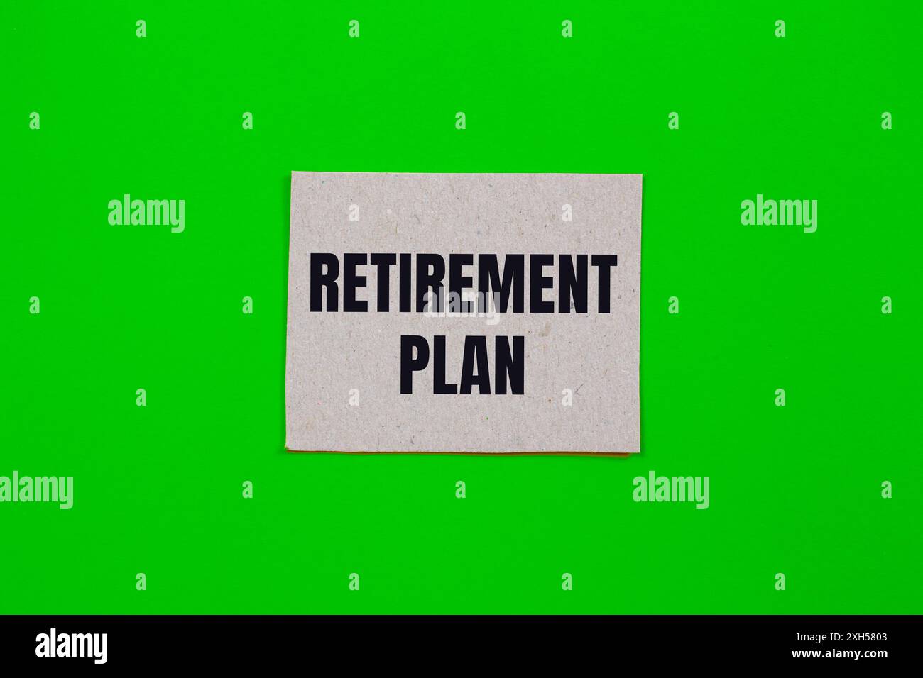 Retirement plan message written on paper piece with green background ...