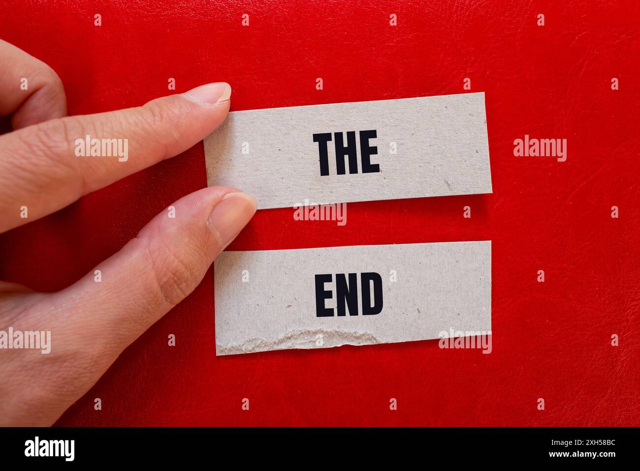 The end message written on paper pieces with red background. Conceptual ...