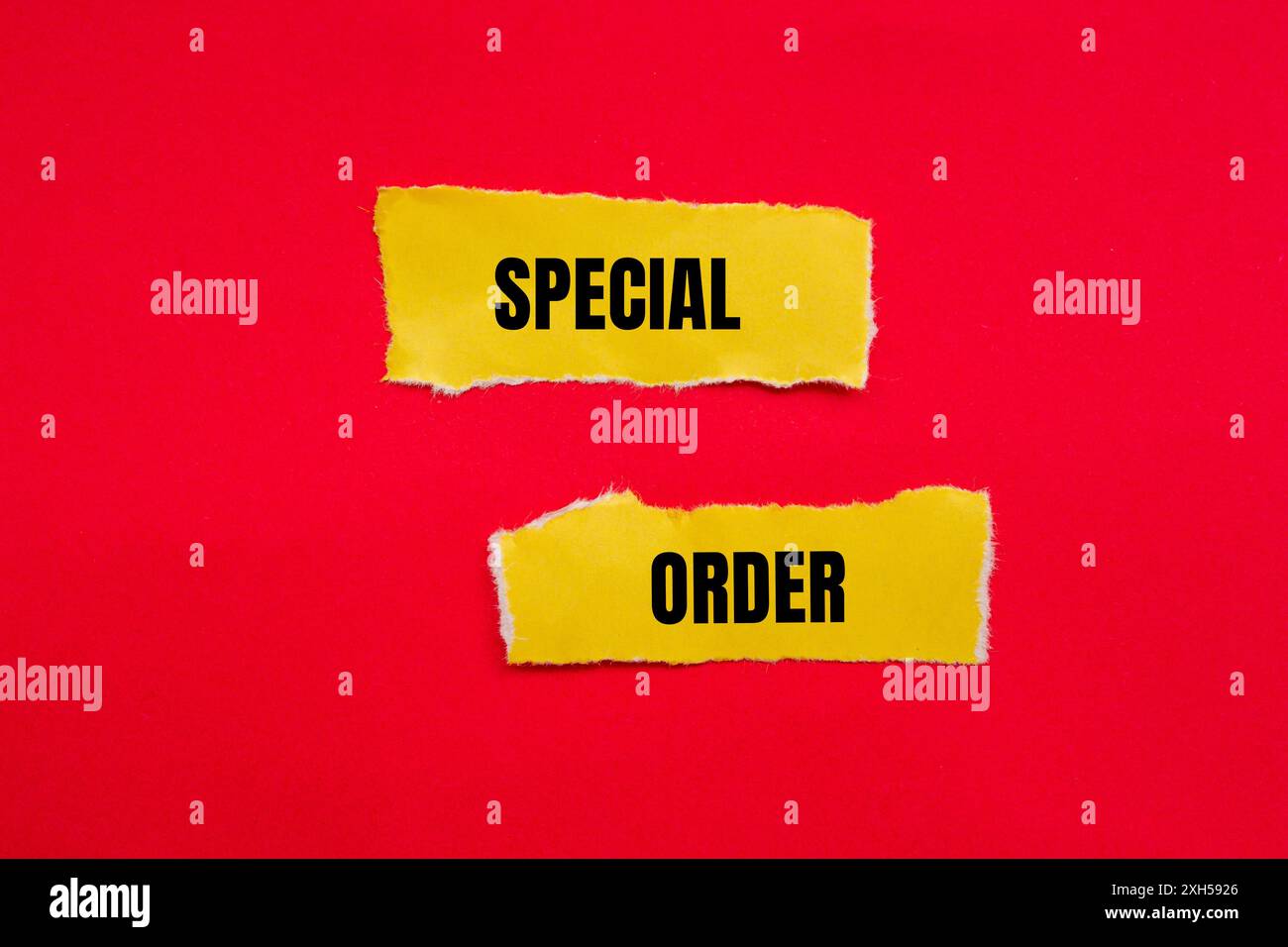 Special order message written on ripped torn yellow paper pieces with red background. Conceptual ...