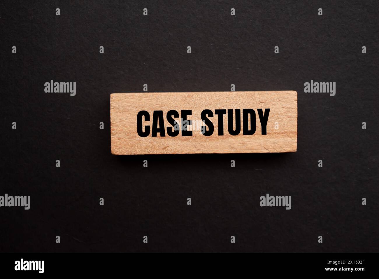 Case study message written on single wooden block with black background ...