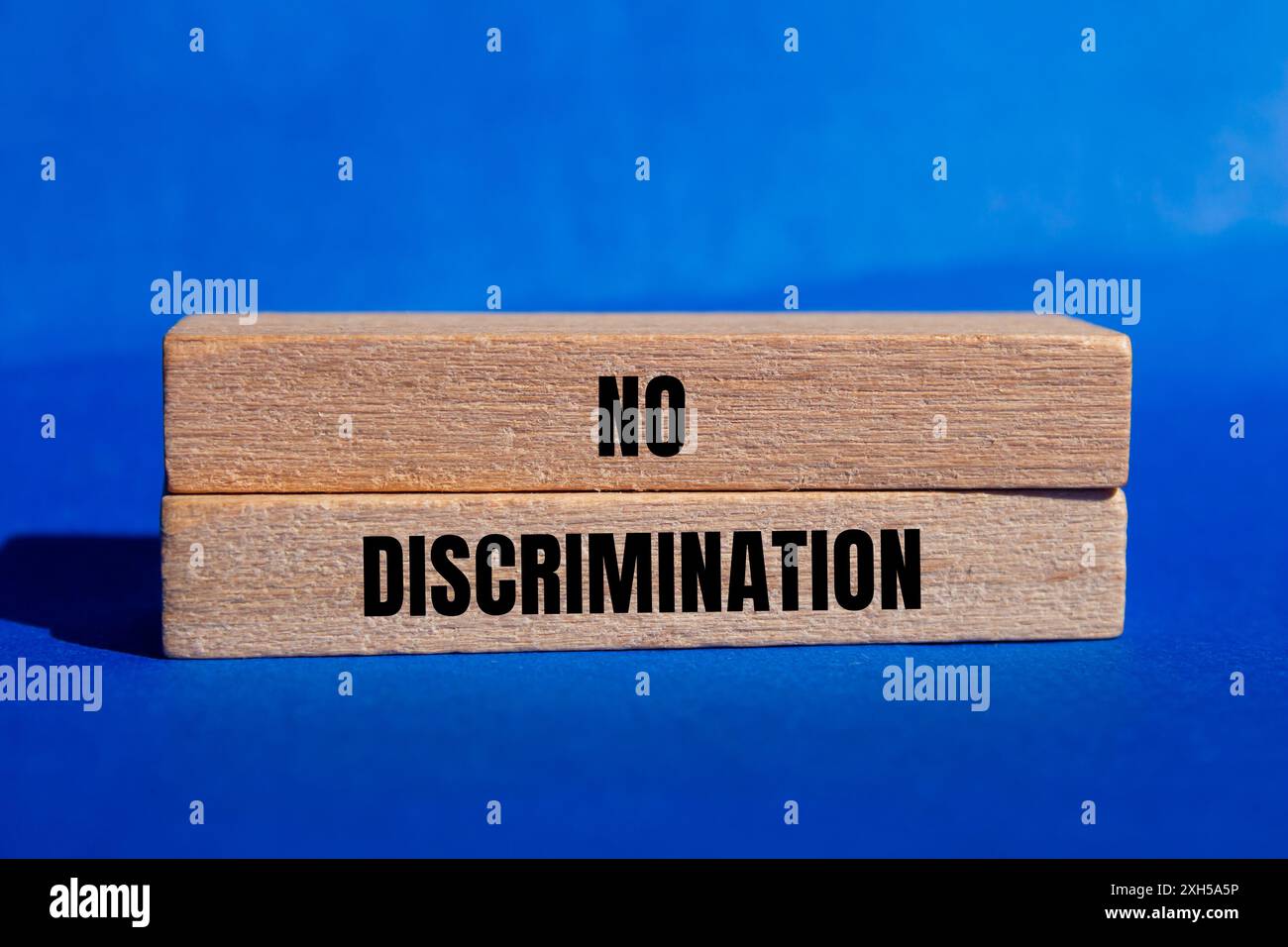 No discrimination message written on wooden blocks with blue background ...