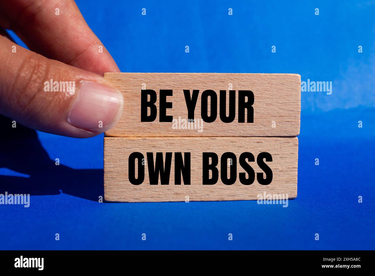 Be your own boss message written on wooden blocks with blue background ...