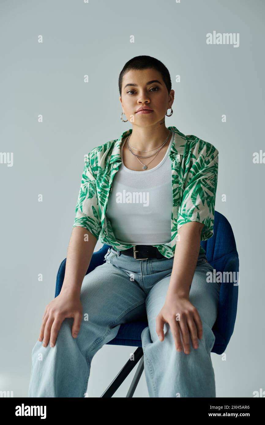 A young woman with short hair in casual wear sitting gracefully atop a ...