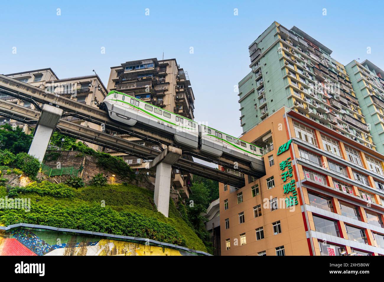 Chongqing, China - 07 May 2024: Train going through a building at ...