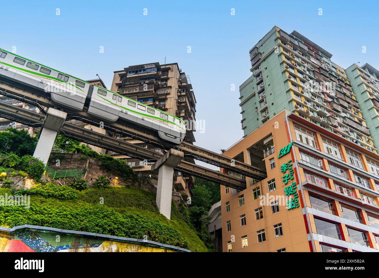 Chongqing, China - 07 May 2024: Train going through a building at ...