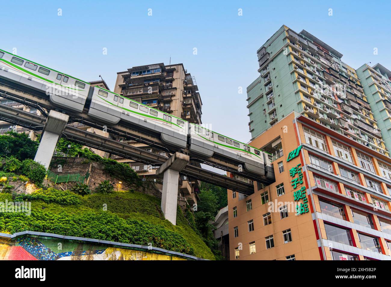 Chongqing, China - 07 May 2024: Train going through a building at ...