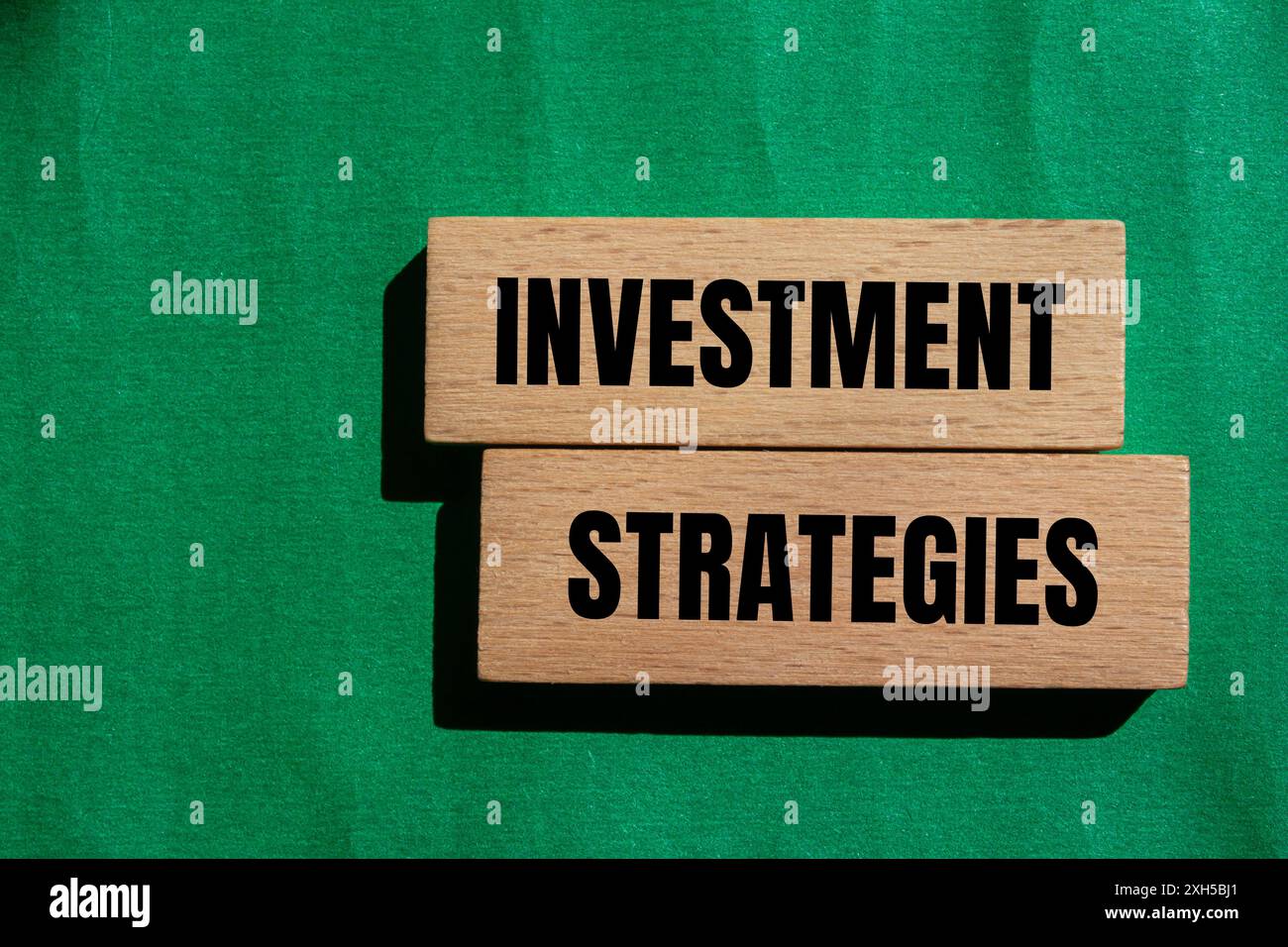 Investment strategies message written on wooden blocks with green ...