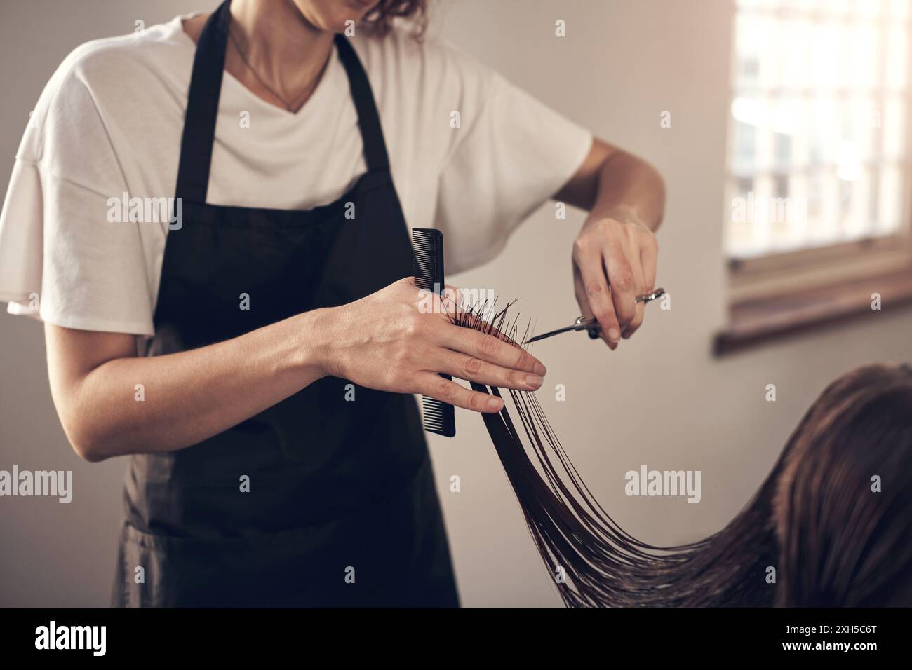 Scissor, haircut and beautician with client in salon for split ends ...