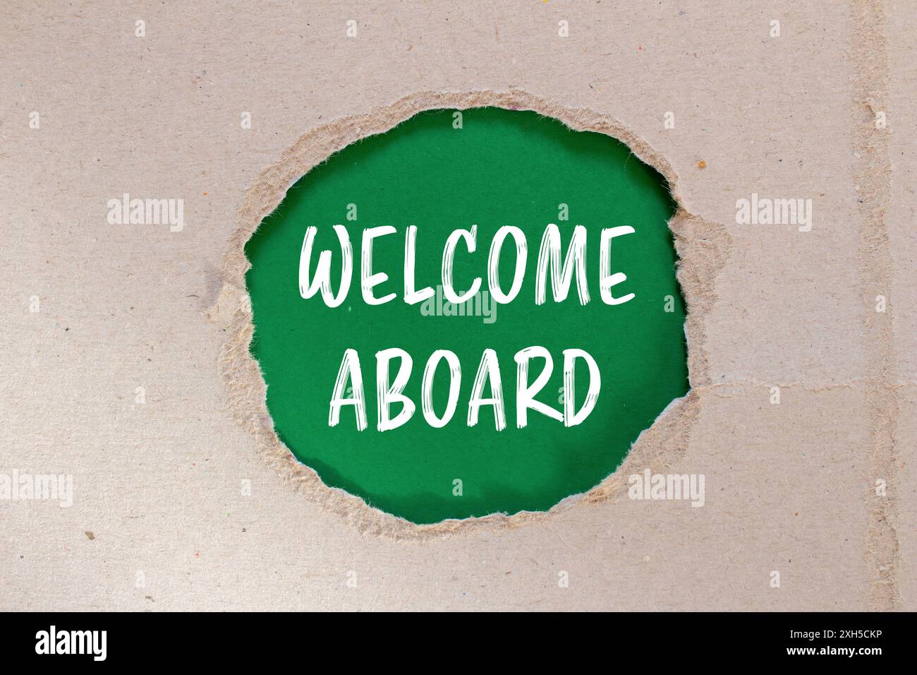 Welcome aboard message written on ripped torn paper with green ...