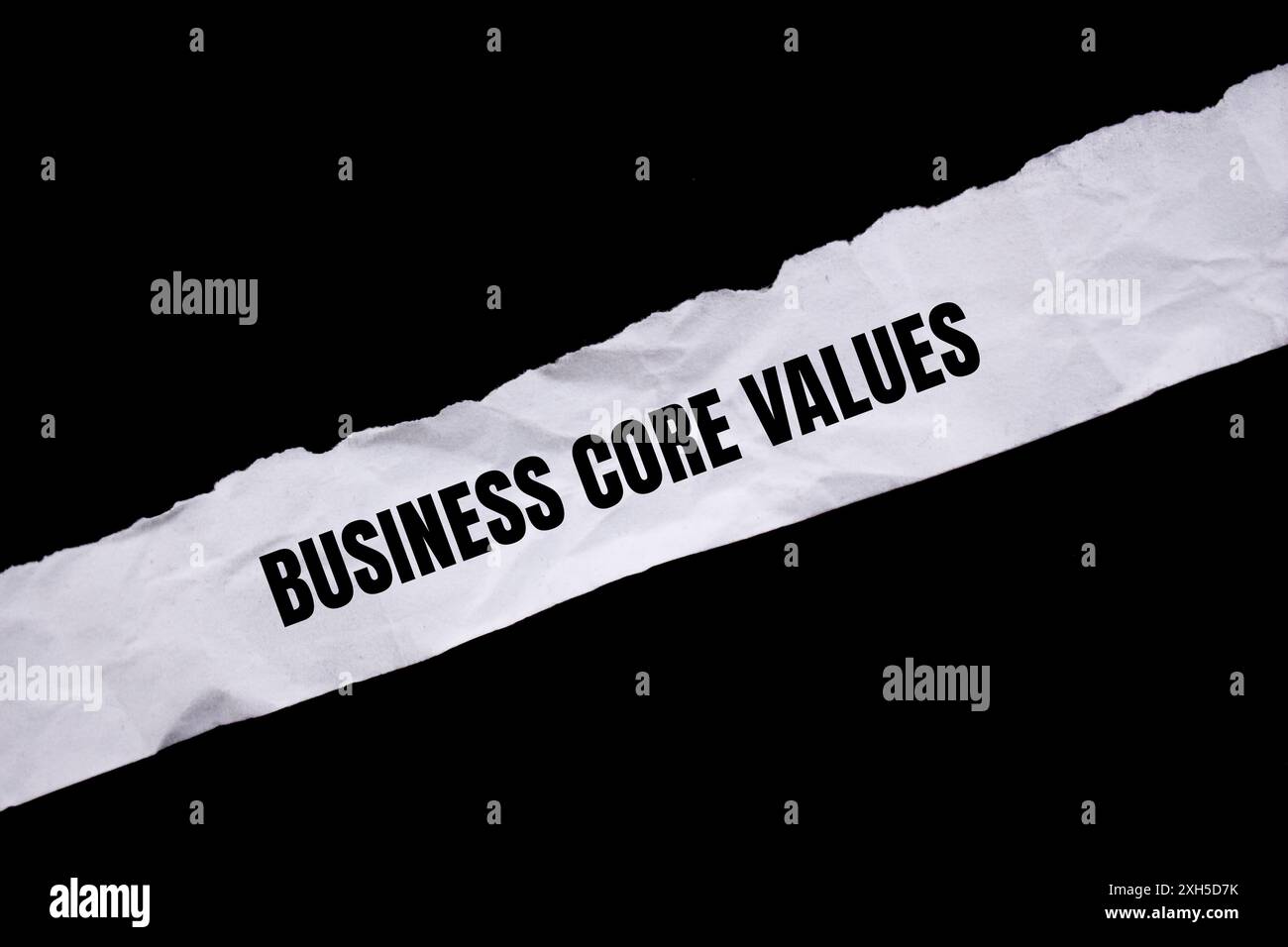 Business core values message written on ripped torn white paper with ...