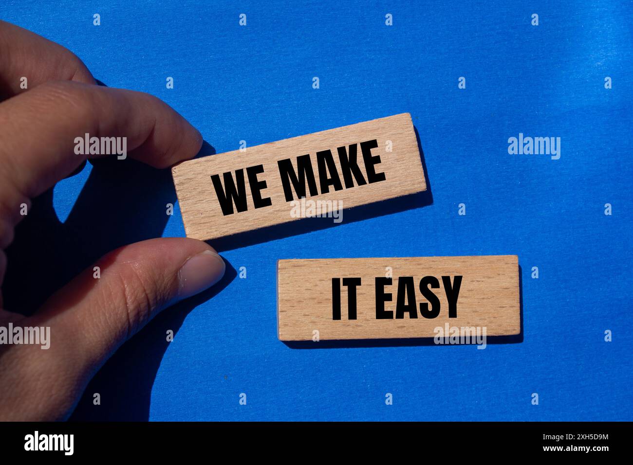 We make it easy message written on wooden blocks with blue background ...