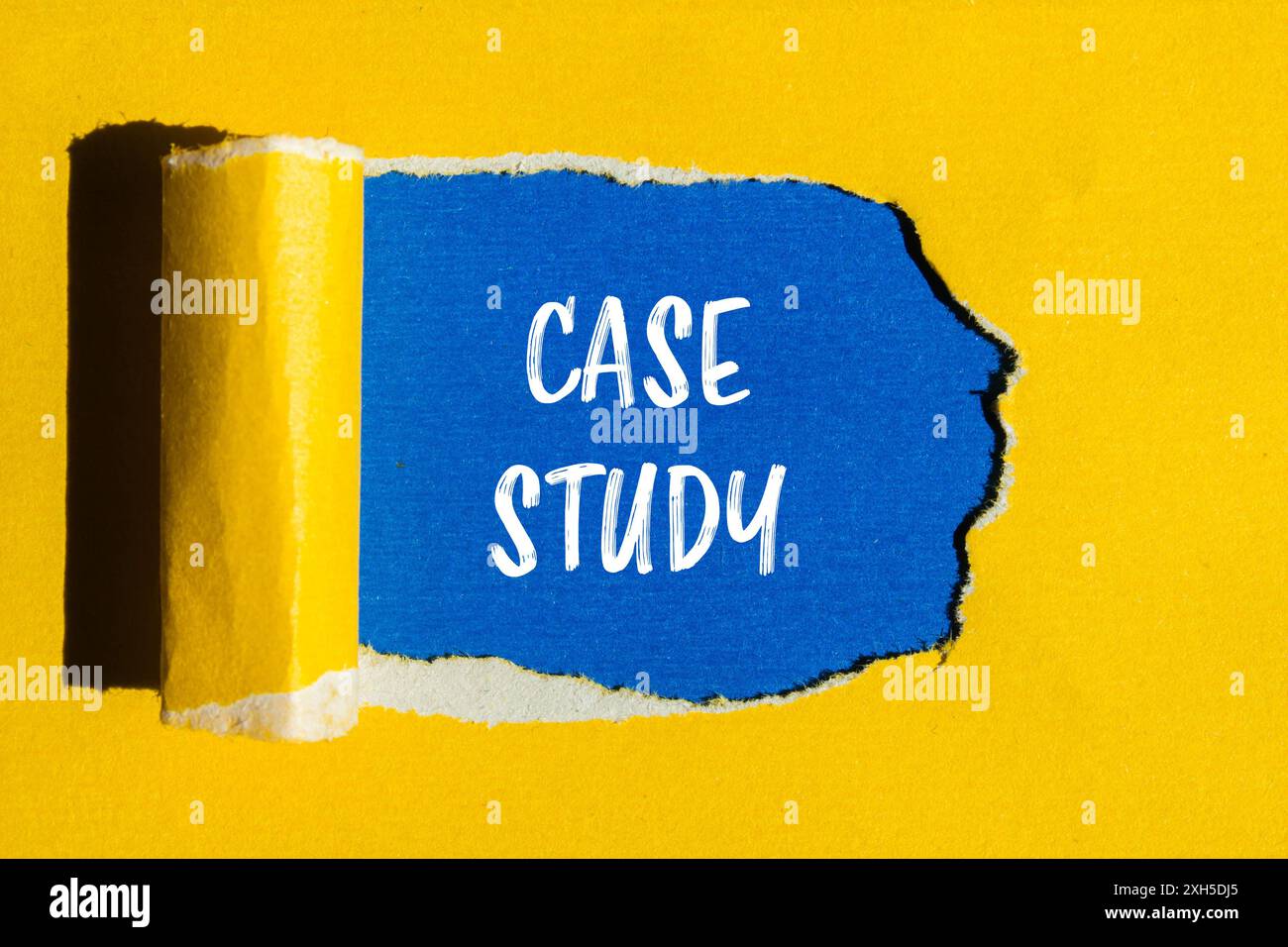 Case study message written on ripped yellow paper with blue background. Conceptual case study ...