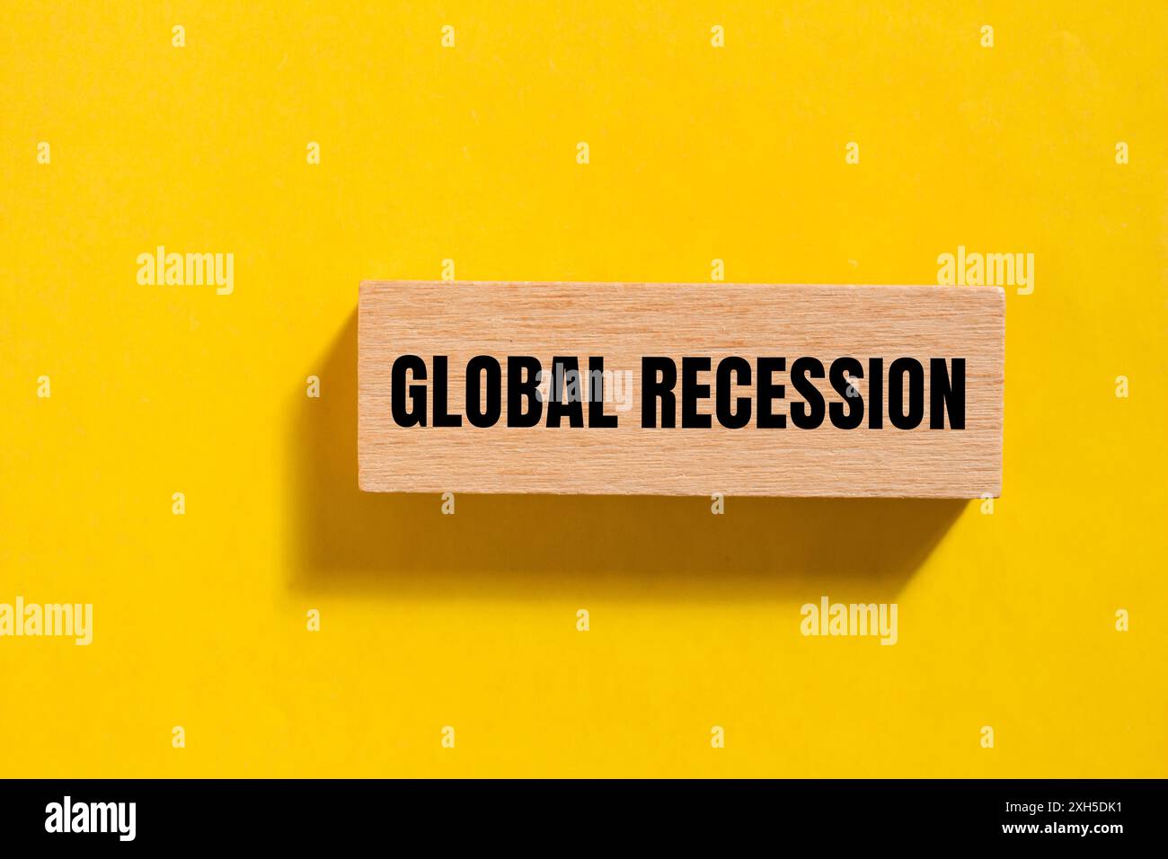 Global recession message written on single wooden block with yellow ...