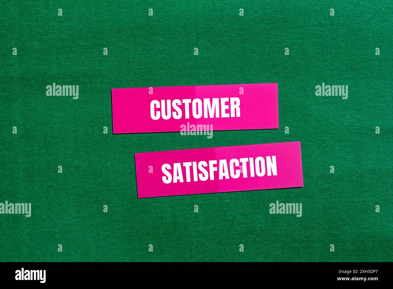 Customer satisfaction message written on pink paper with green ...